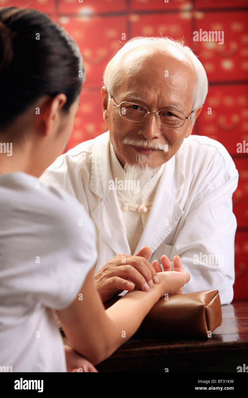 Chinese traditional herbalist doctor taking patient's pulse Stock Photo ...