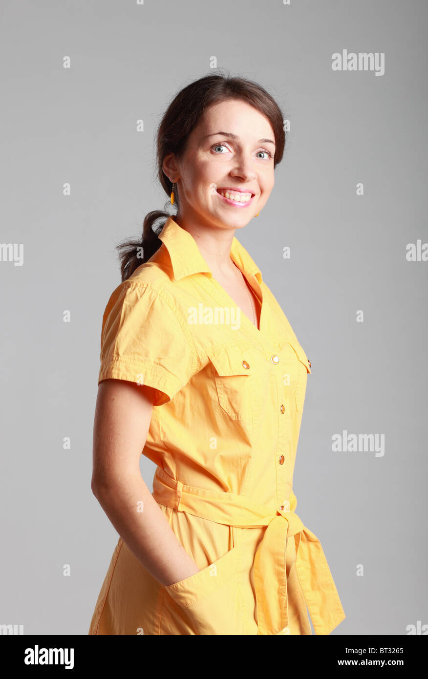 The woman in a yellow working dress Stock Photo - Alamy