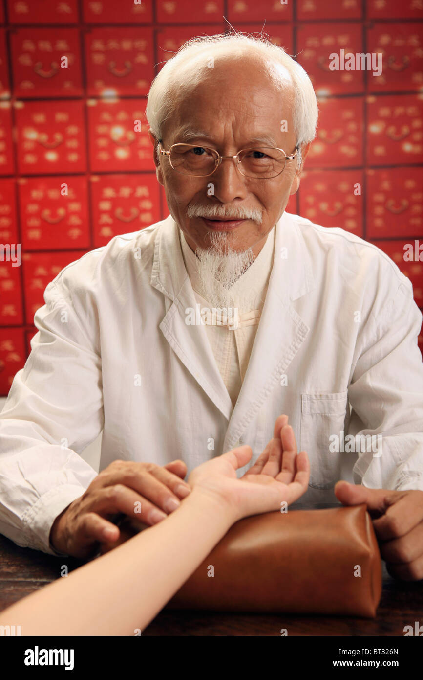 Chinese traditional herbalist doctor taking patient's pulse Stock Photo ...
