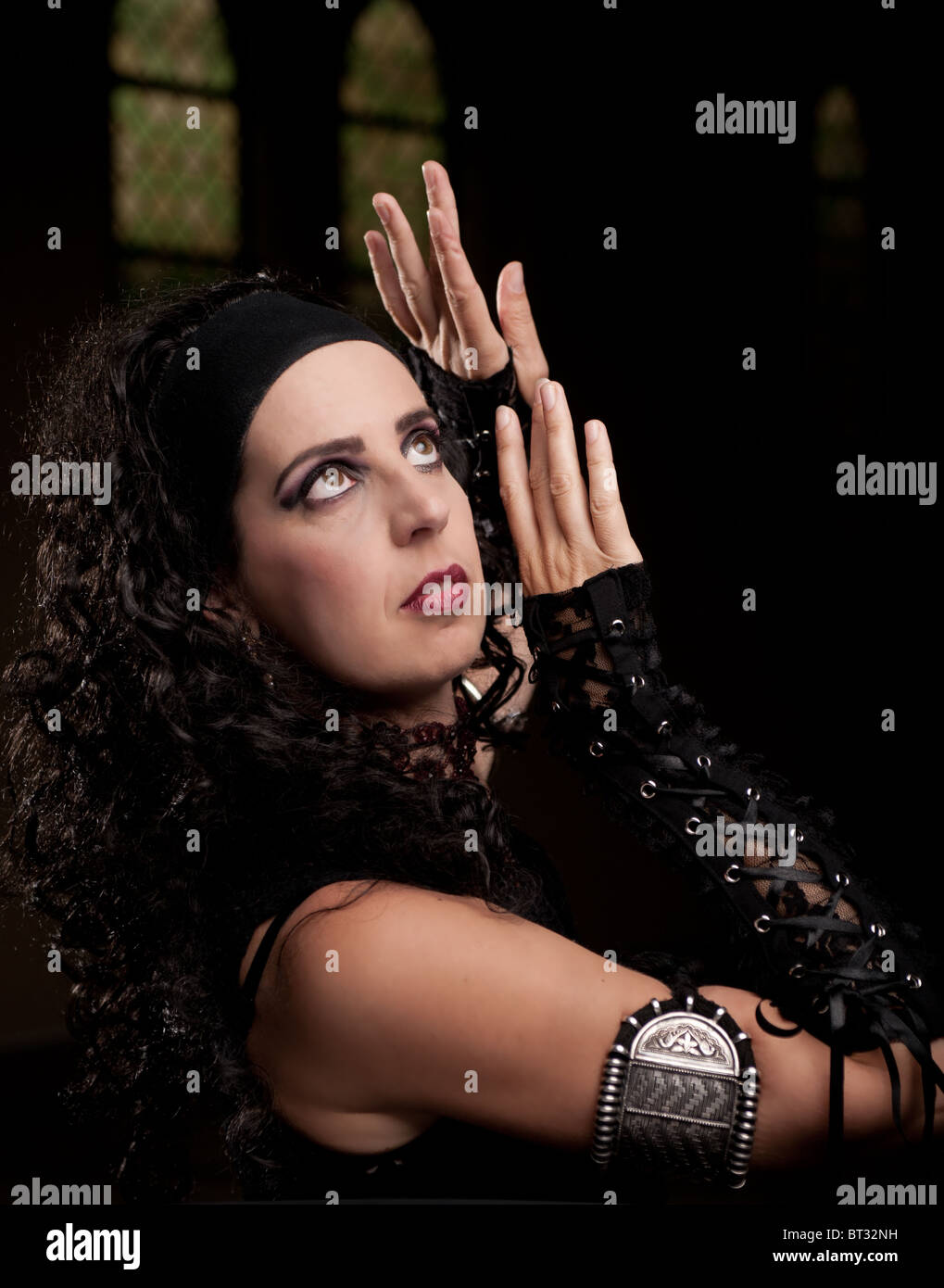 Gothic-style dancer with jewelry looking up Stock Photo - Alamy