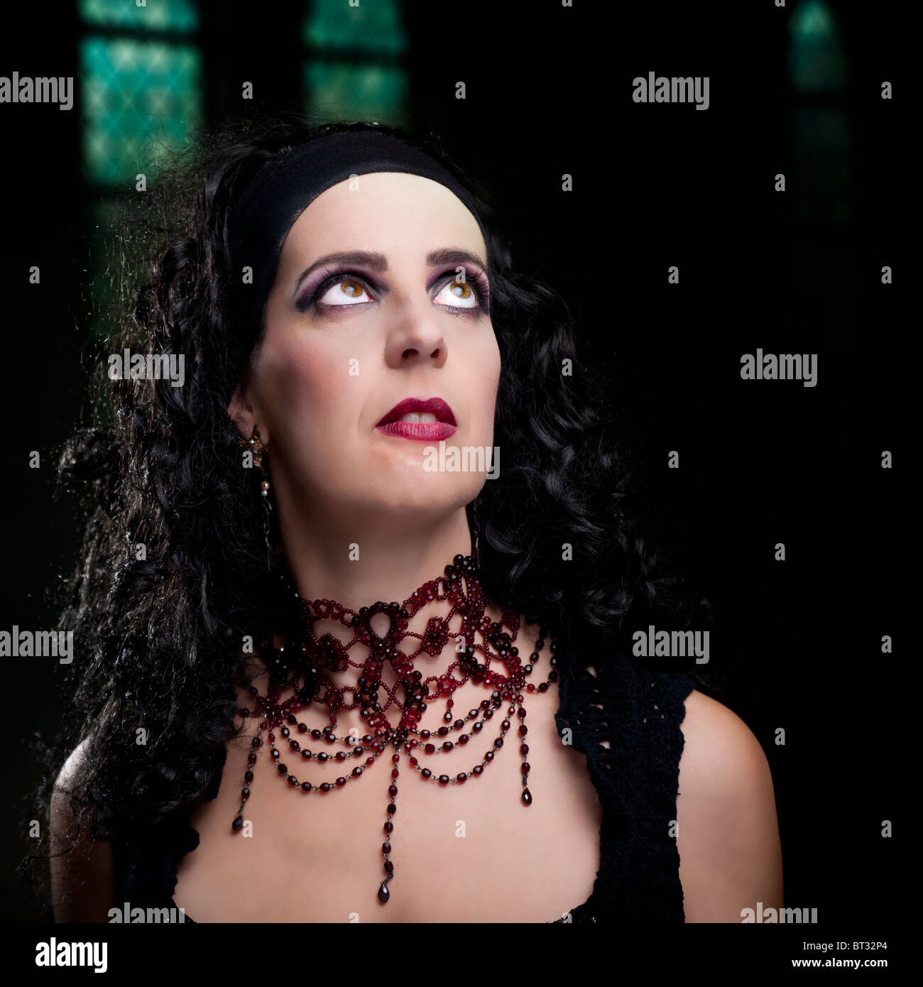Gothic-style dancer with jewelry looking up Stock Photo - Alamy