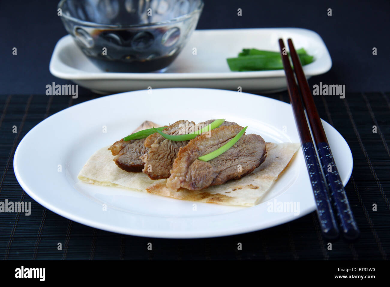 Prepared meat duck fillet on a plate on a black background Stock Photo ...
