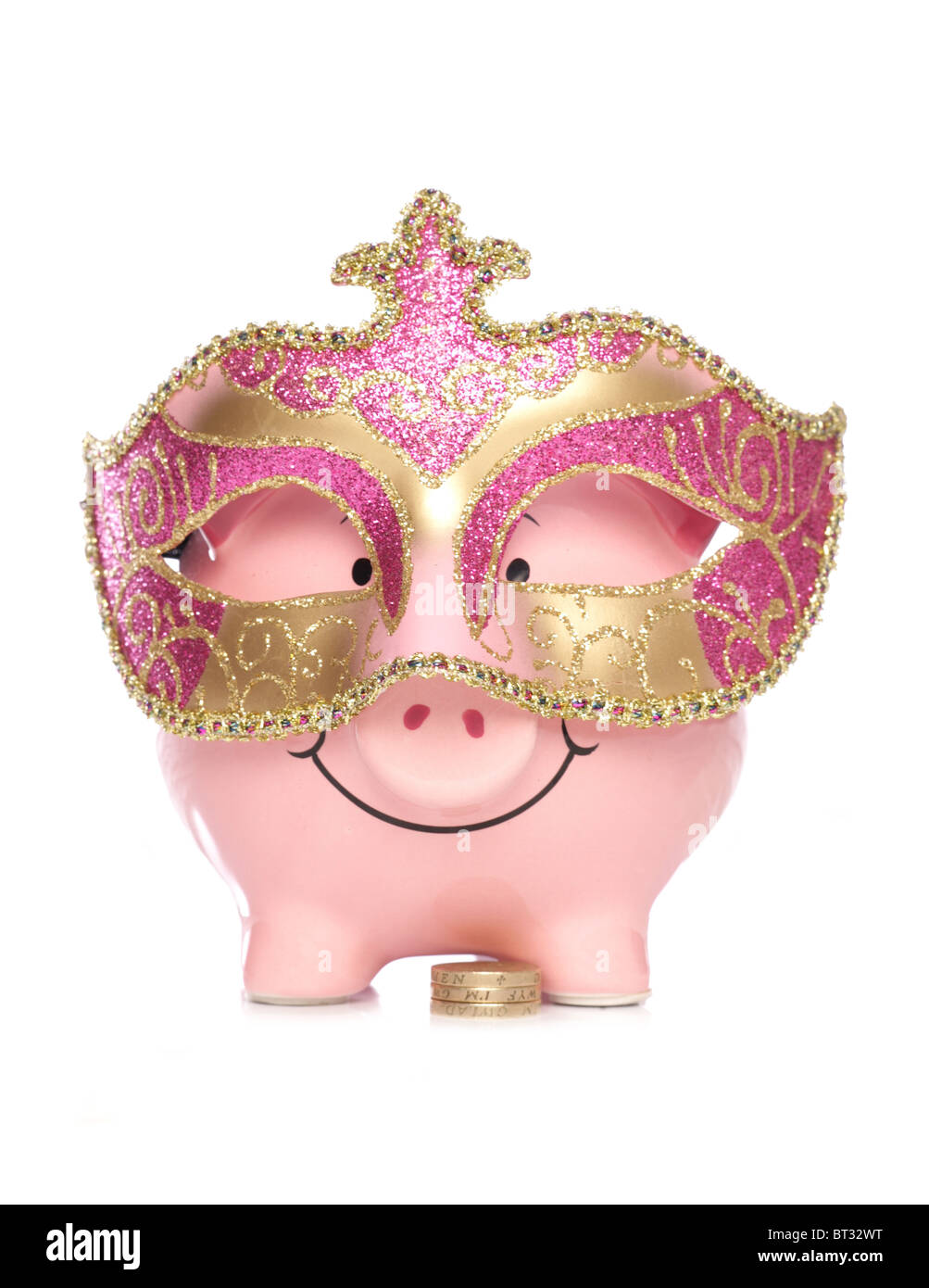 Piggy bank with masquerade party mask cutout Stock Photo - Alamy