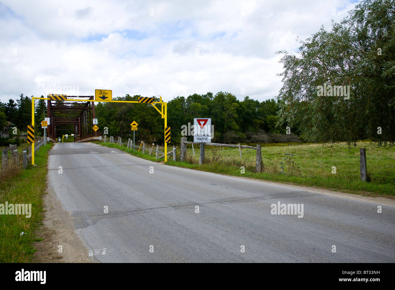 Bridge with height restriction warning Stock Photo - Alamy