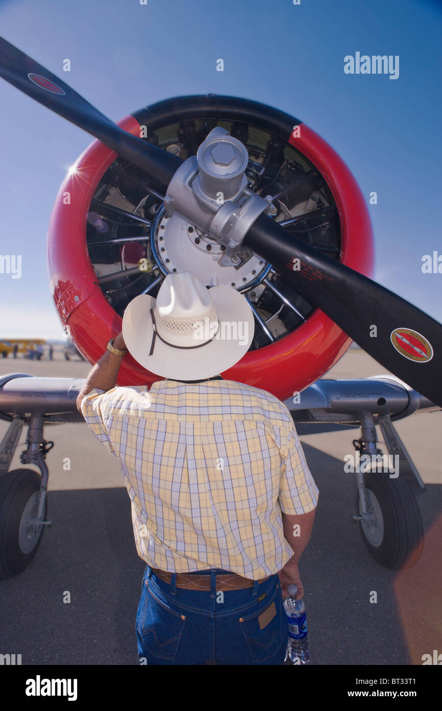 A Texan inspects the radial engine of a North American Aviation T-6 ...