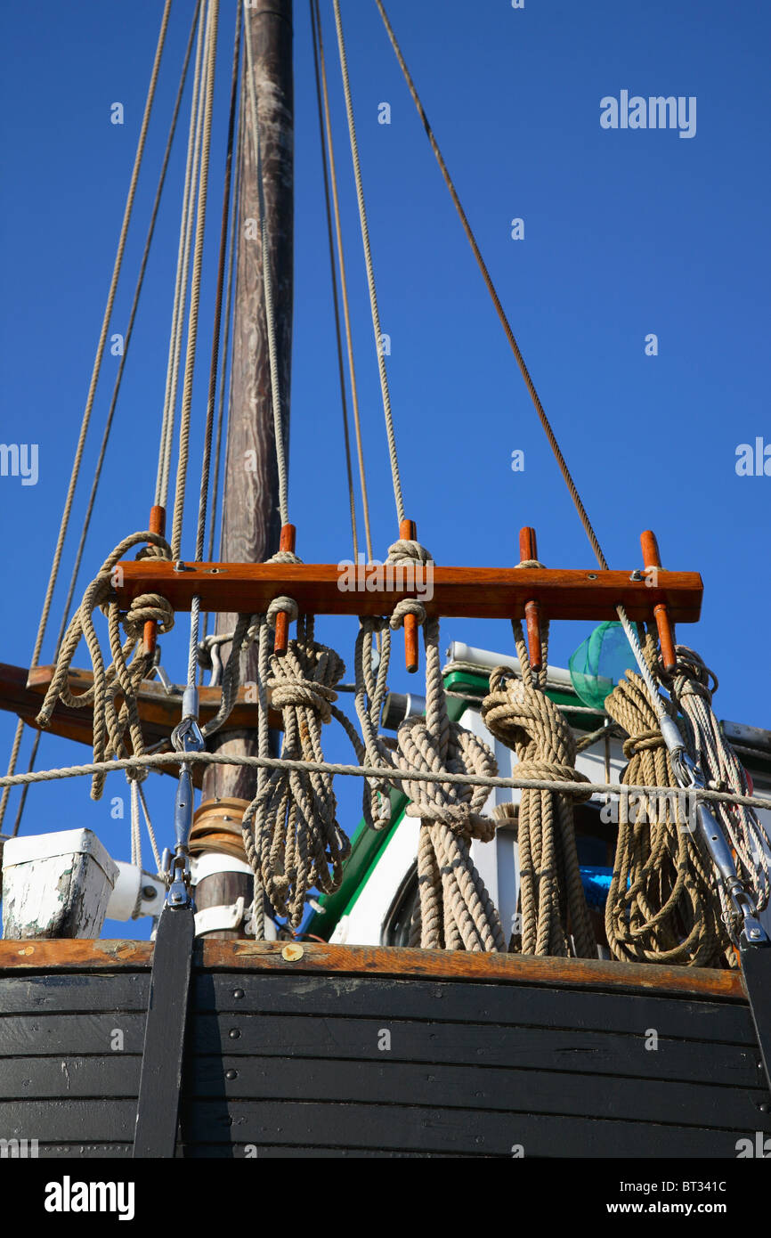 Old sailing ship and fishing vessel with coiled rope and various ...