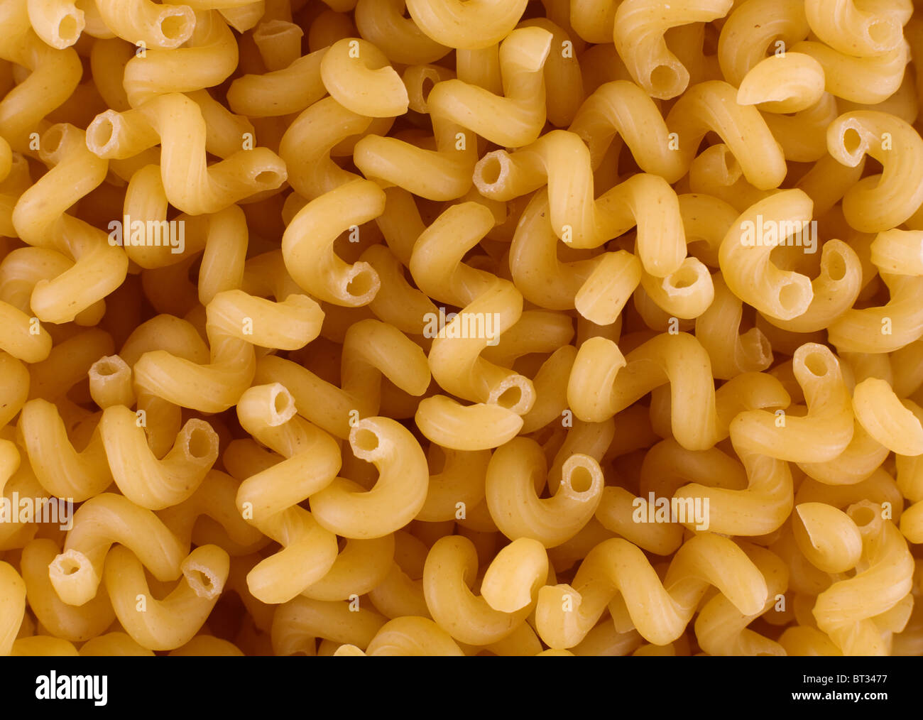 Texture consisting of dry macaroni on a plate surface Stock Photo - Alamy