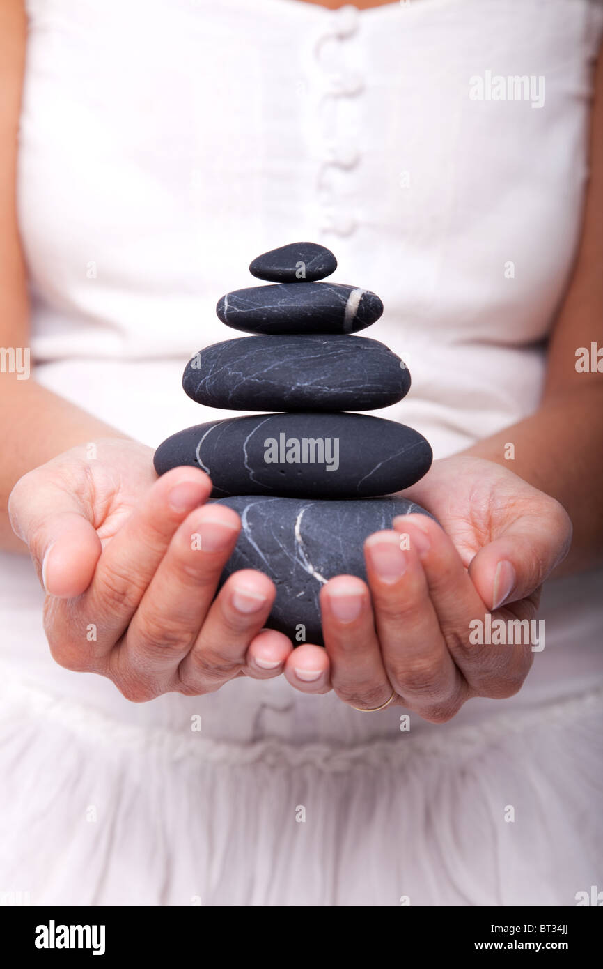 hands holding a stack of black stones (selective focus Stock Photo - Alamy