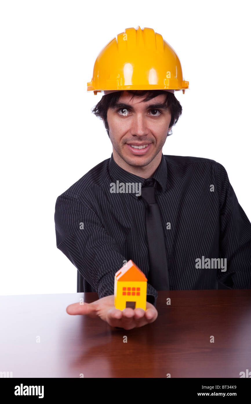 young construction engineer showing you a small yellow house Stock ...
