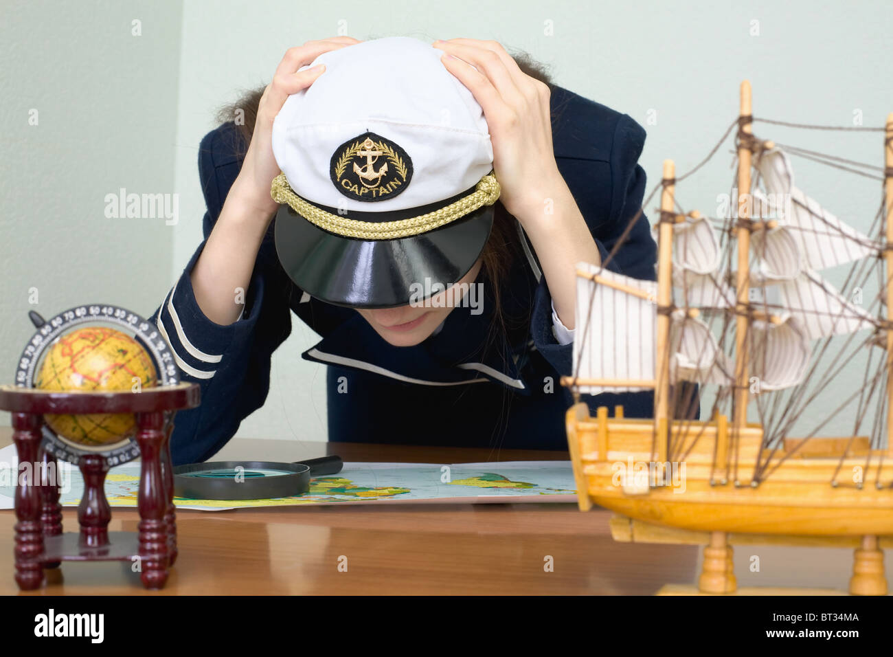 Girl - the sea captain with a card in office Stock Photo - Alamy