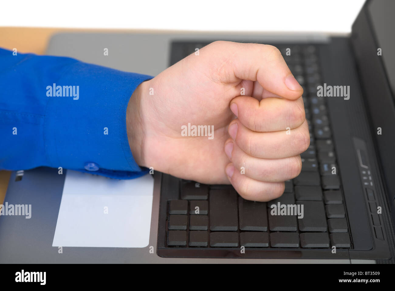 Fist on the laptop on the white background Stock Photo - Alamy