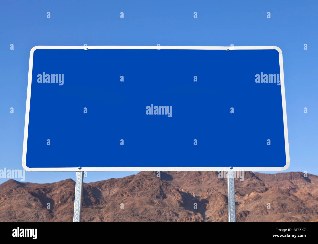 Big blank blue road sign with desert mountain background Stock Photo ...
