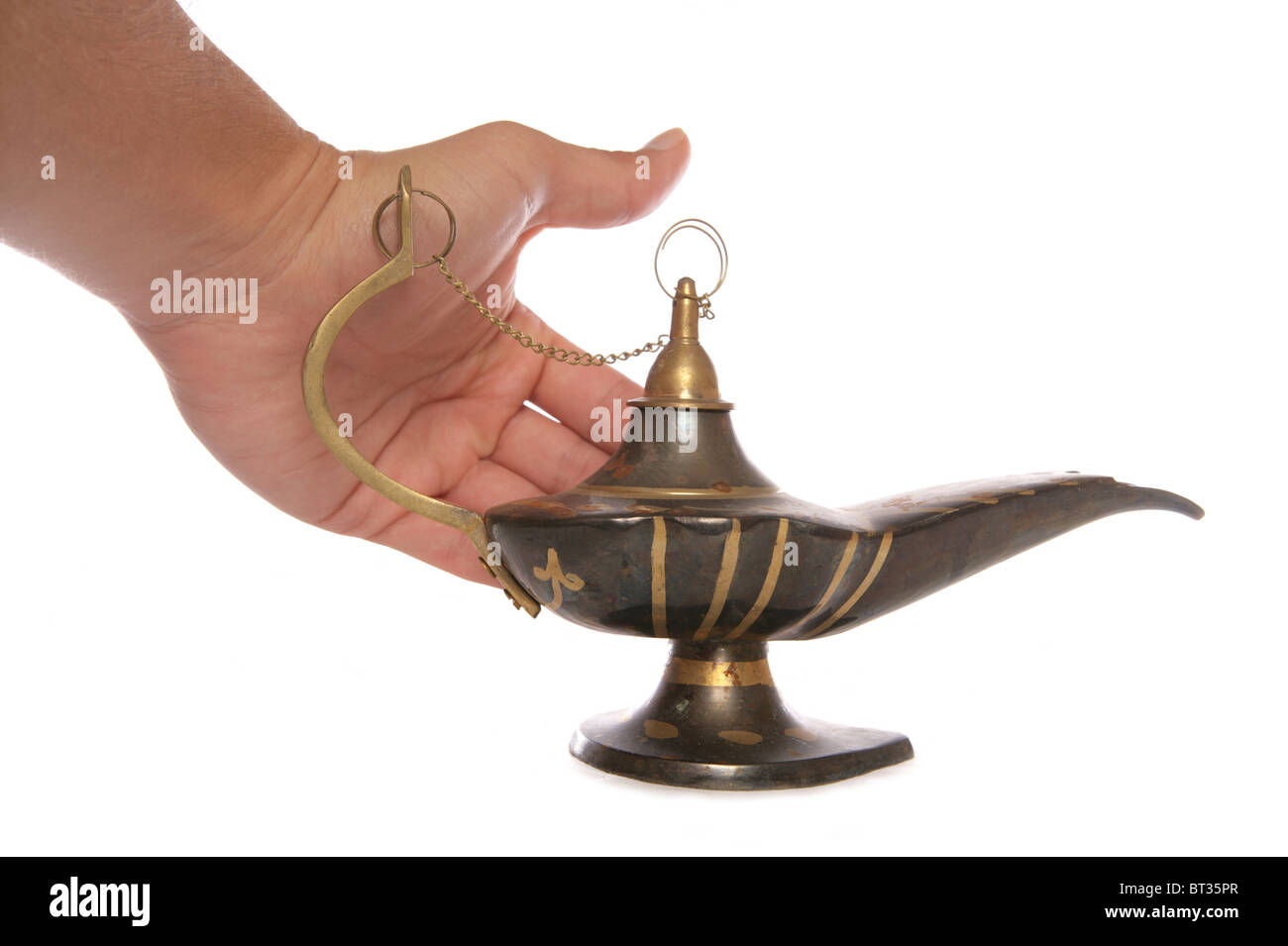 Rubbing an Old Magic Lamp studio cutout Stock Photo - Alamy