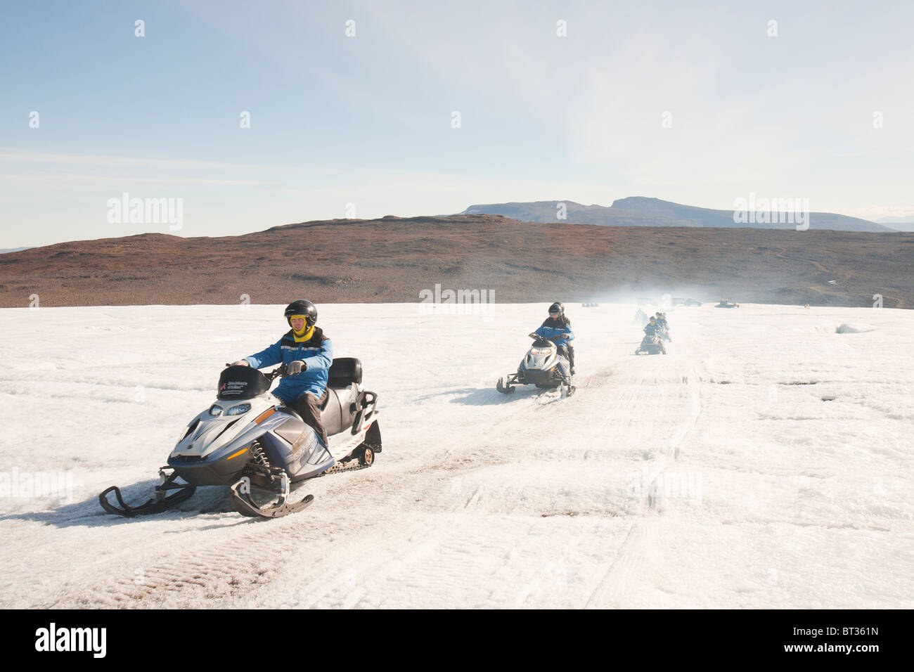 Tourists riding through a stinking fog of exhaust fumes from skidoos on ...