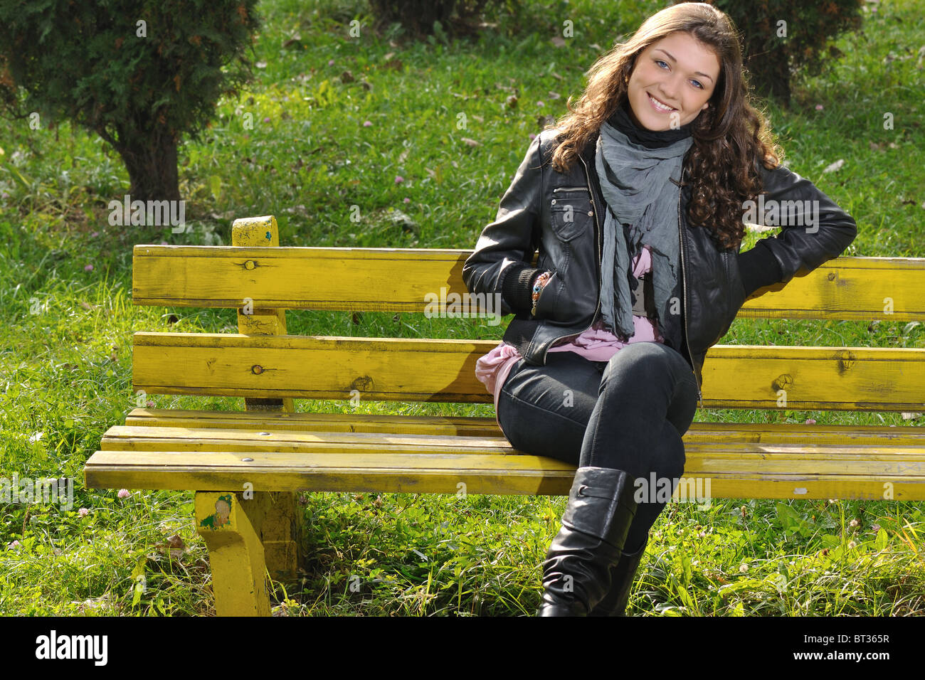 Beautiful teenager with lovely smile sitting on bench in park Stock ...