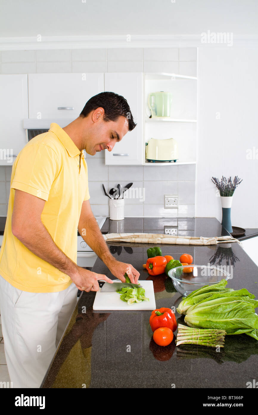 young man cooking in kitchen Stock Photo - Alamy