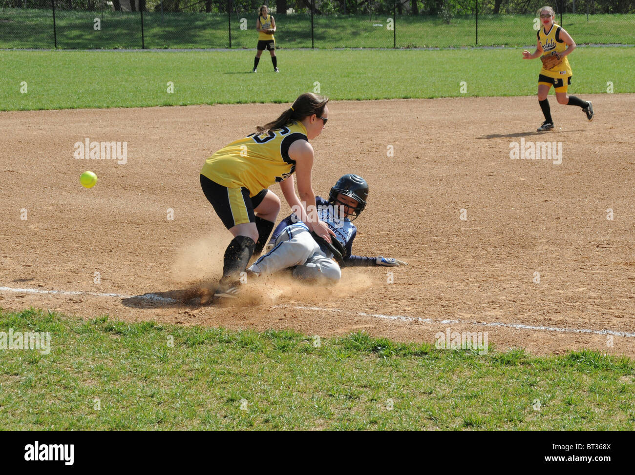 3rd baseman misses the tag in a high school softball game Stock Photo ...