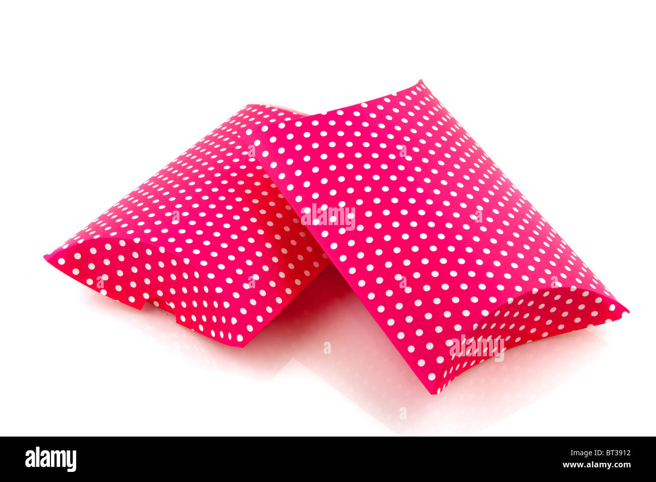 Two pink dotted presents over white background Stock Photo - Alamy