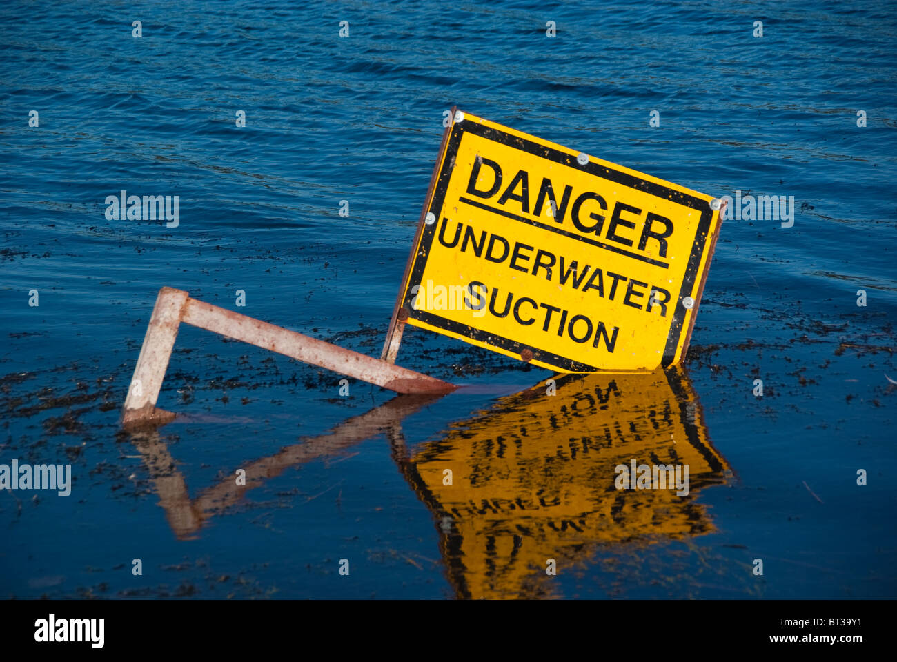 Danger beware sign at edge of lake Stock Photo - Alamy
