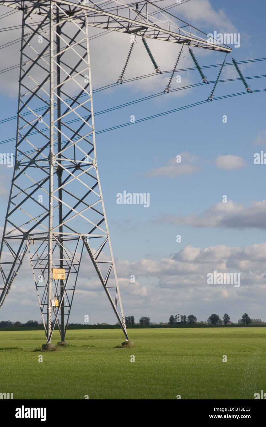Part of a pylon an a green field Stock Photo - Alamy