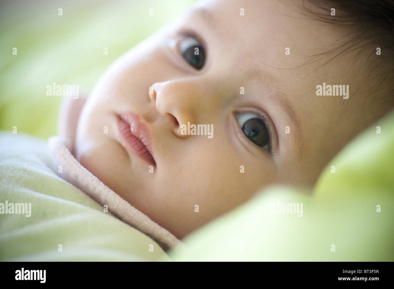 Baby girl looking back Stock Photo - Alamy