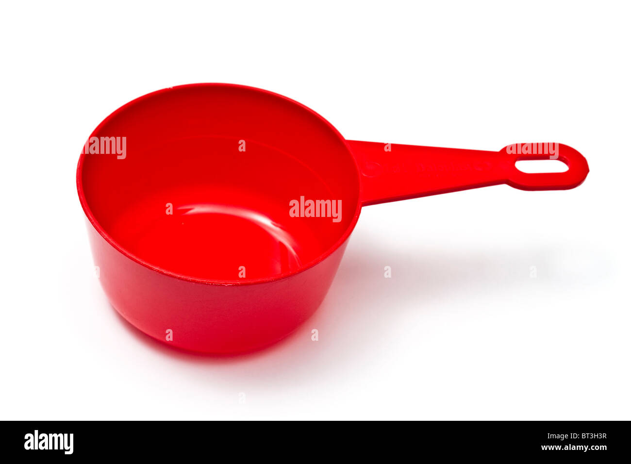 Red plastic measuring cup isolated on white background Stock Photo - Alamy