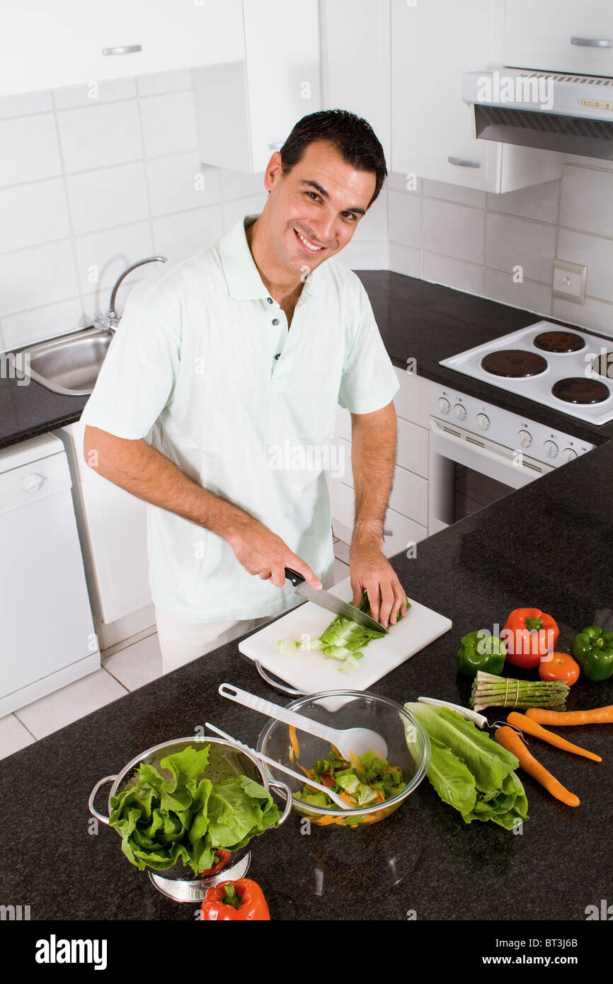 happy young man cooking in kitchen Stock Photo - Alamy