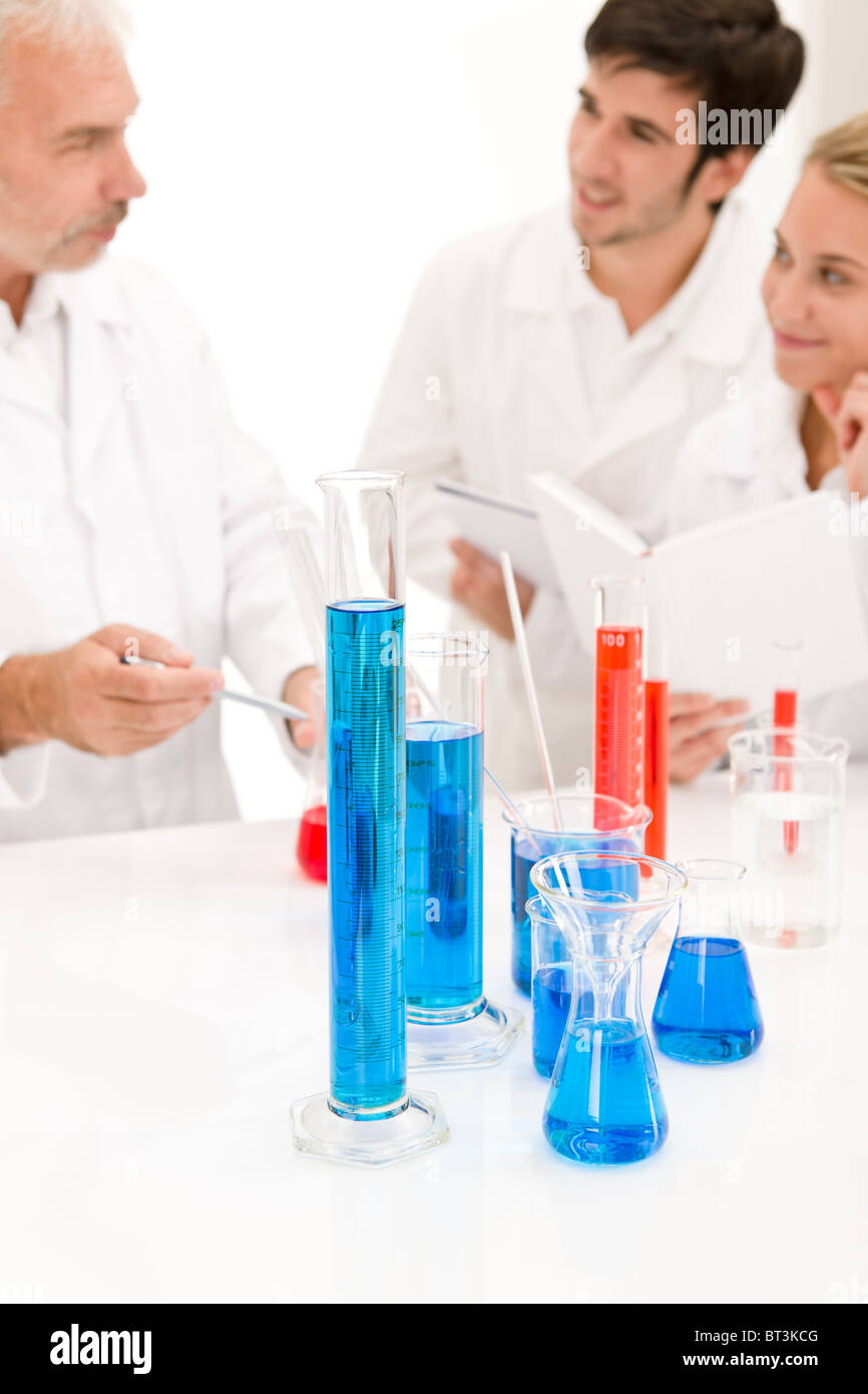 Team of scientists in laboratory - medical research, blue liquid in ...