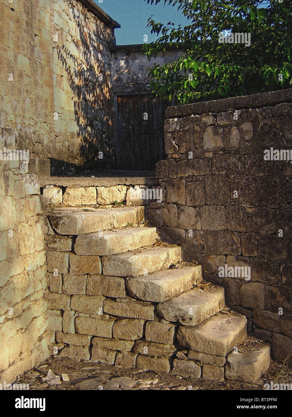 Old stone steps lading up to a house in Cyprus in summer sunlinght ...