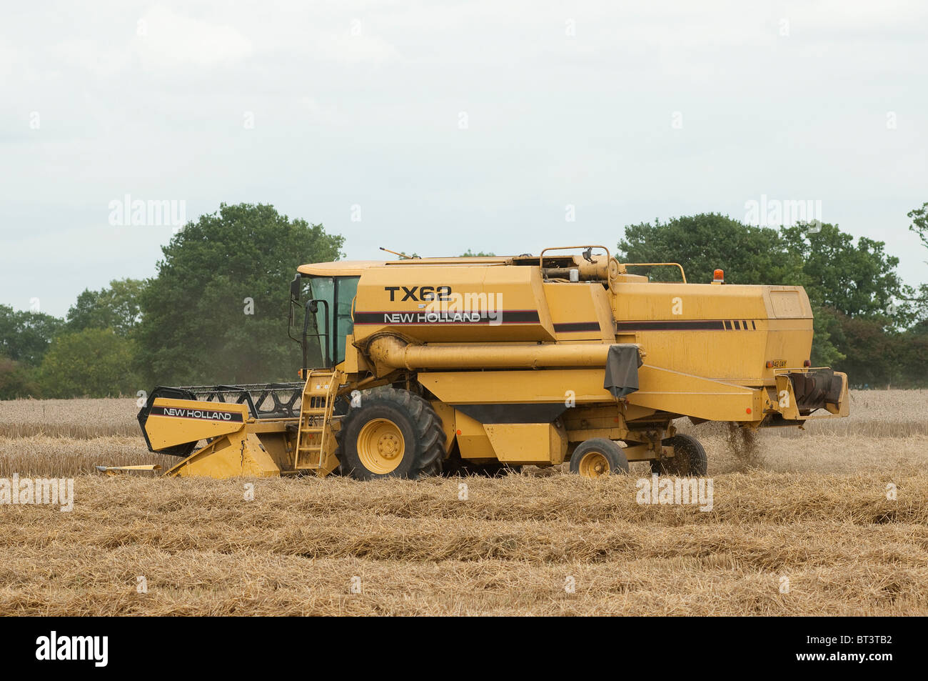Yellow new holland tx62 combine harvester at work in a farmers field in ...