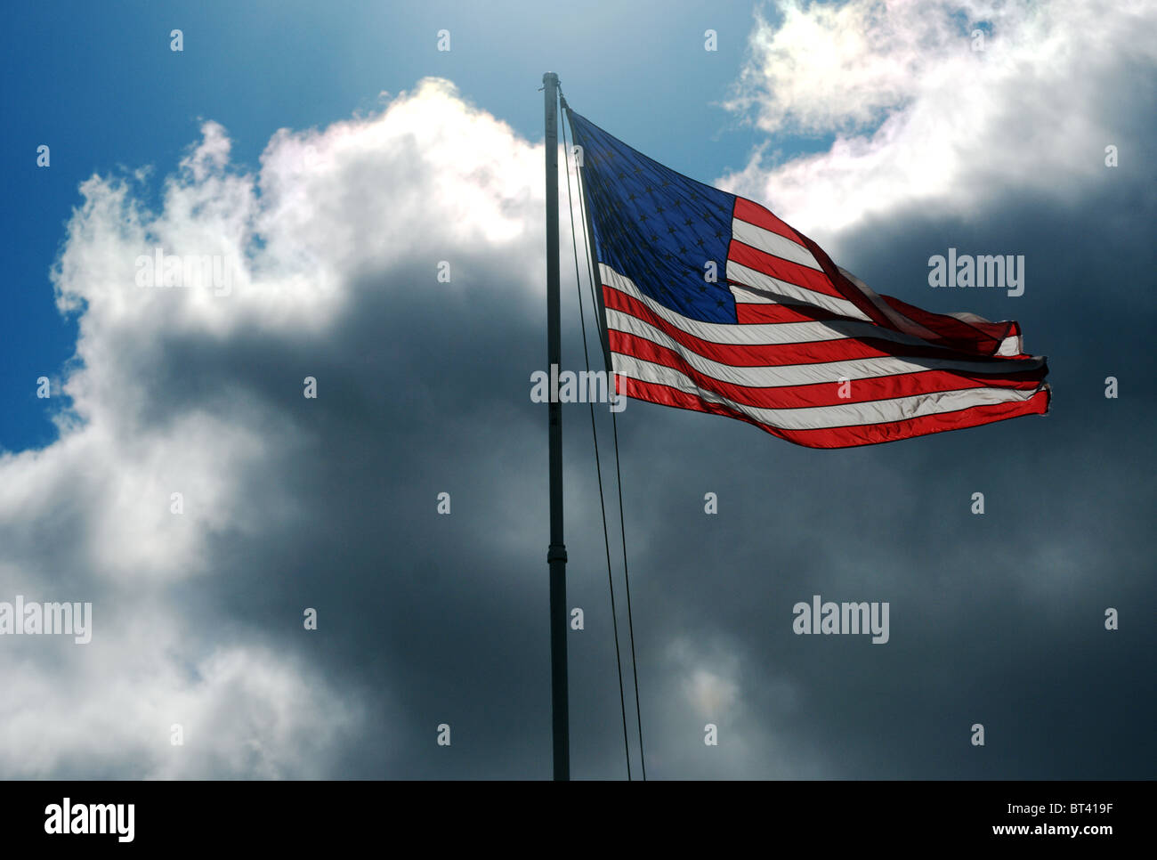 American flag waves in stiff breeze Stock Photo - Alamy