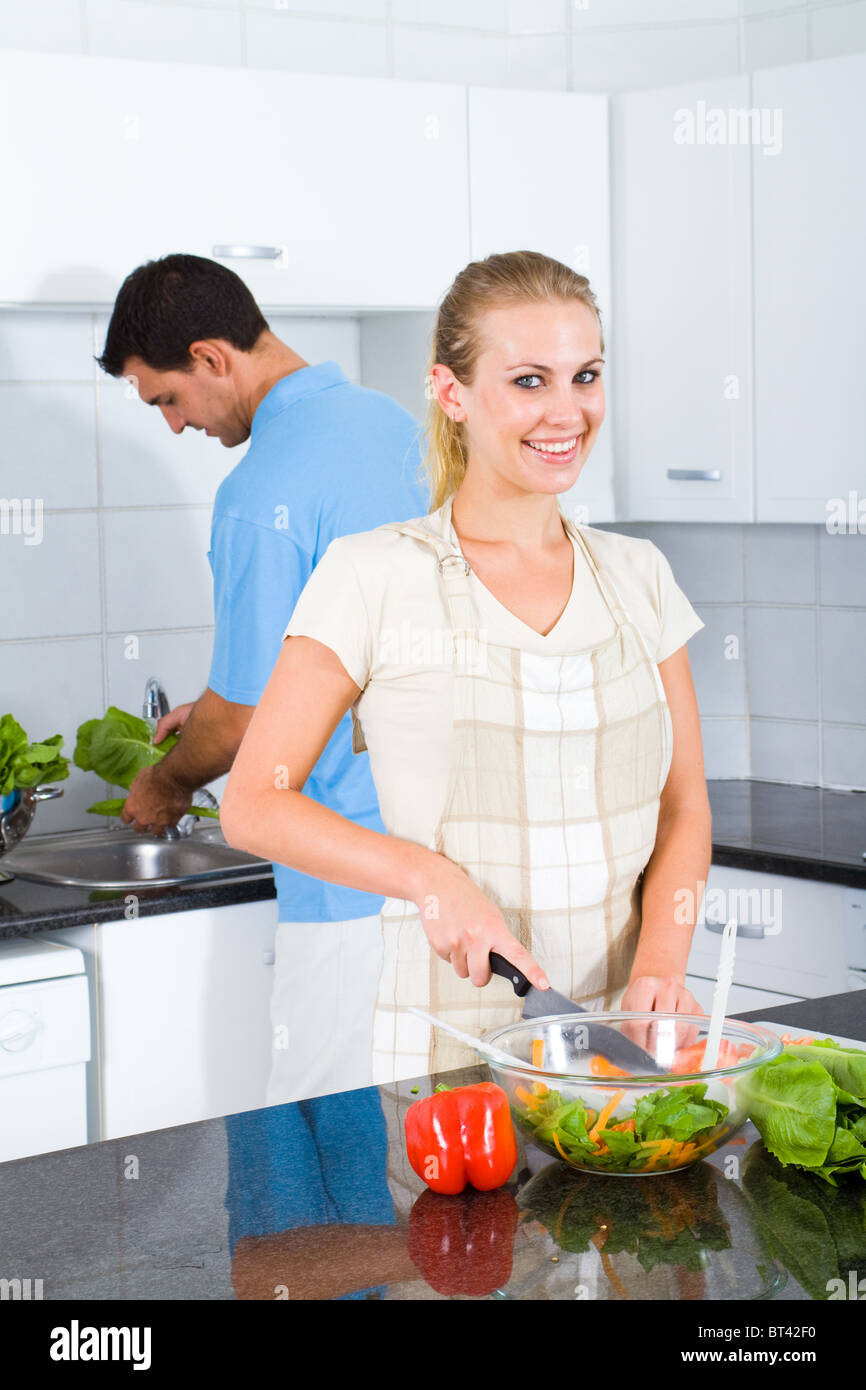 happy young couple cooking in kitchen Stock Photo - Alamy