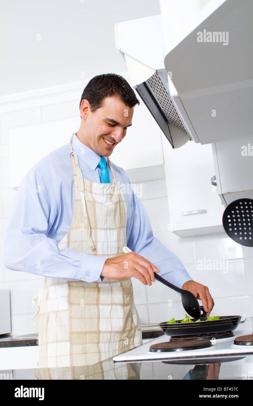 young man stir fry vegetable in kitchen Stock Photo - Alamy