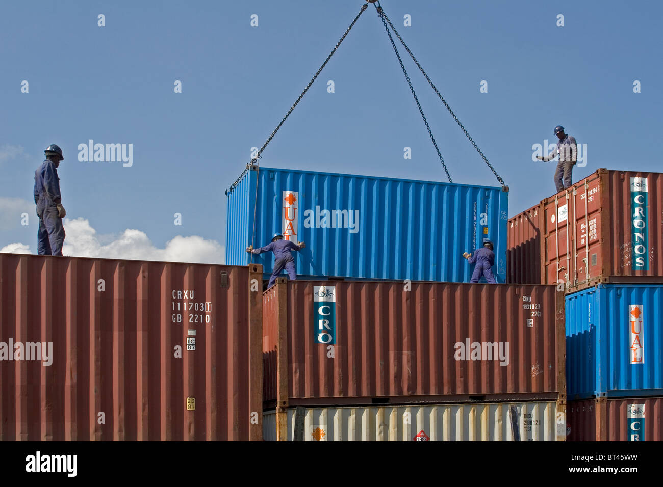 Luba Oil Freeport. Stevedores loading containers onto ship from ...