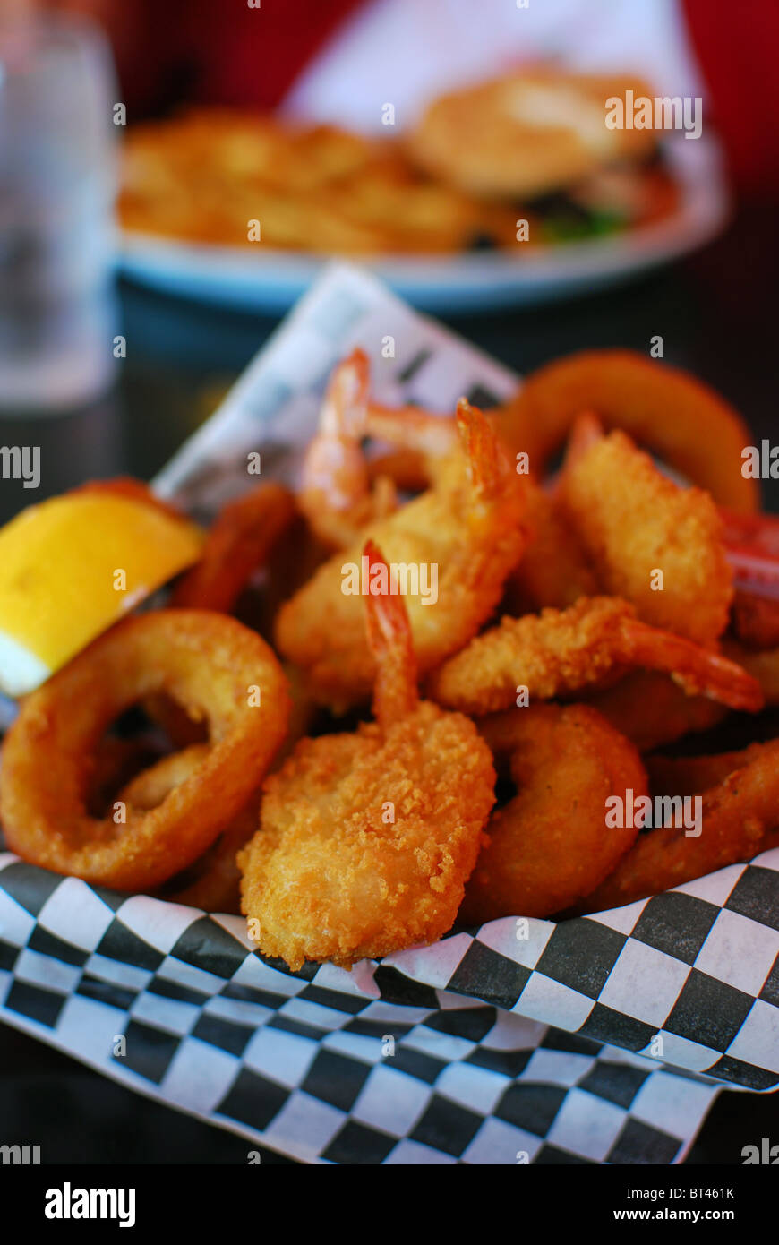 Deep fried shrimp basket with fried onion rings at a diner. Oregon OR ...