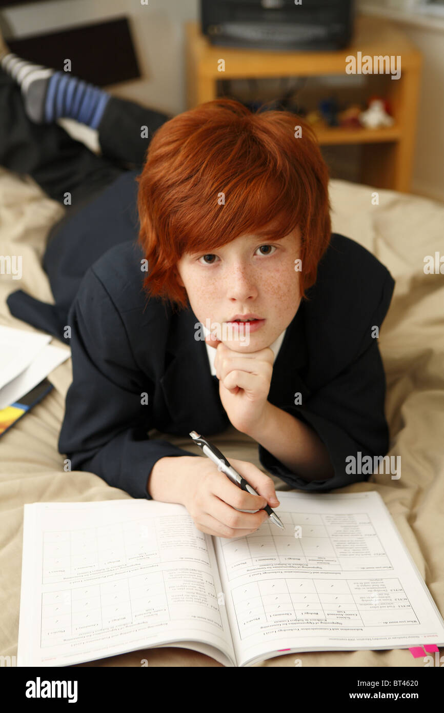 Schoolboy doing his homework in the bedroom Stock Photo - Alamy