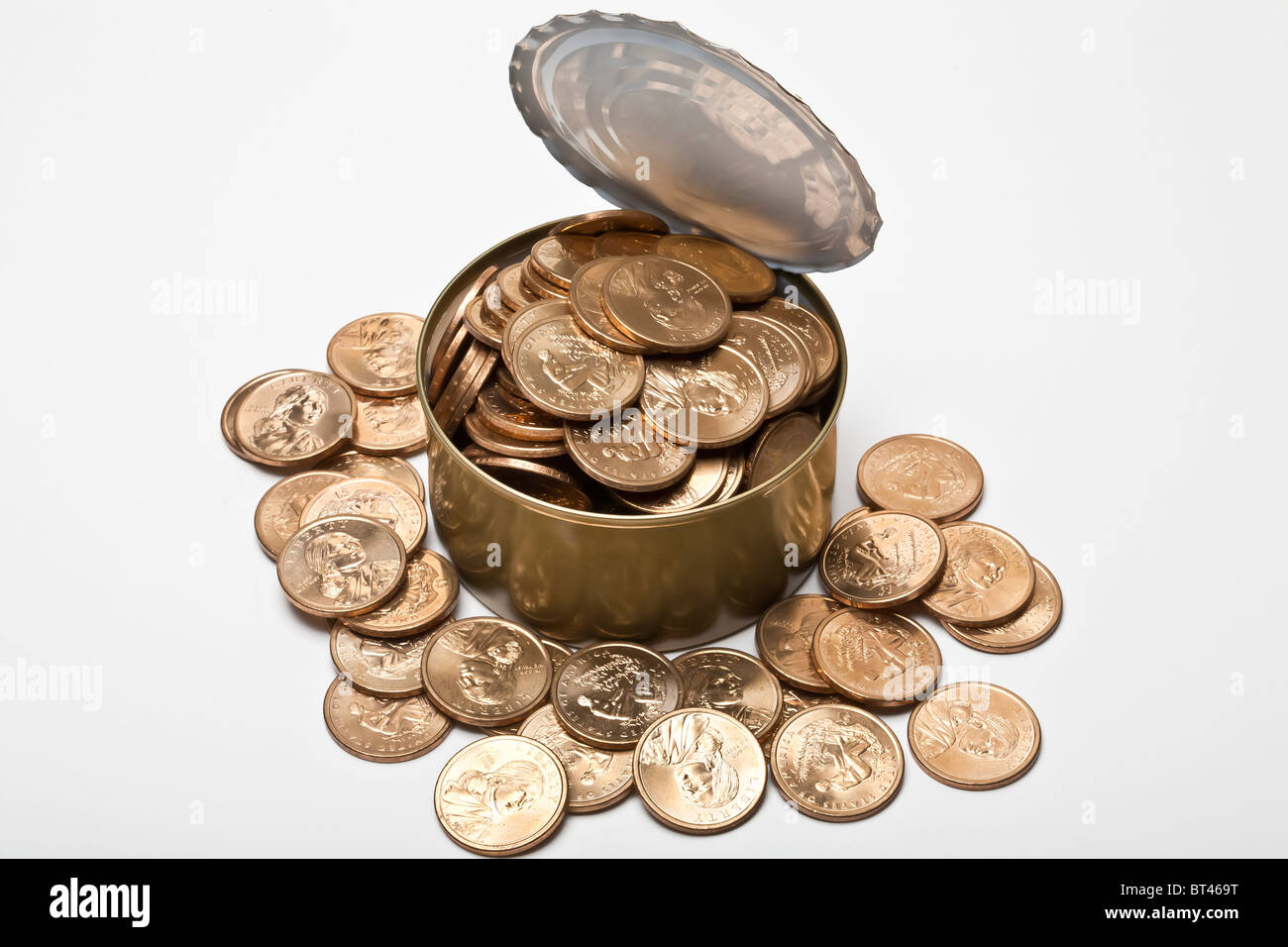 Open can of gold US dollar coins Stock Photo - Alamy