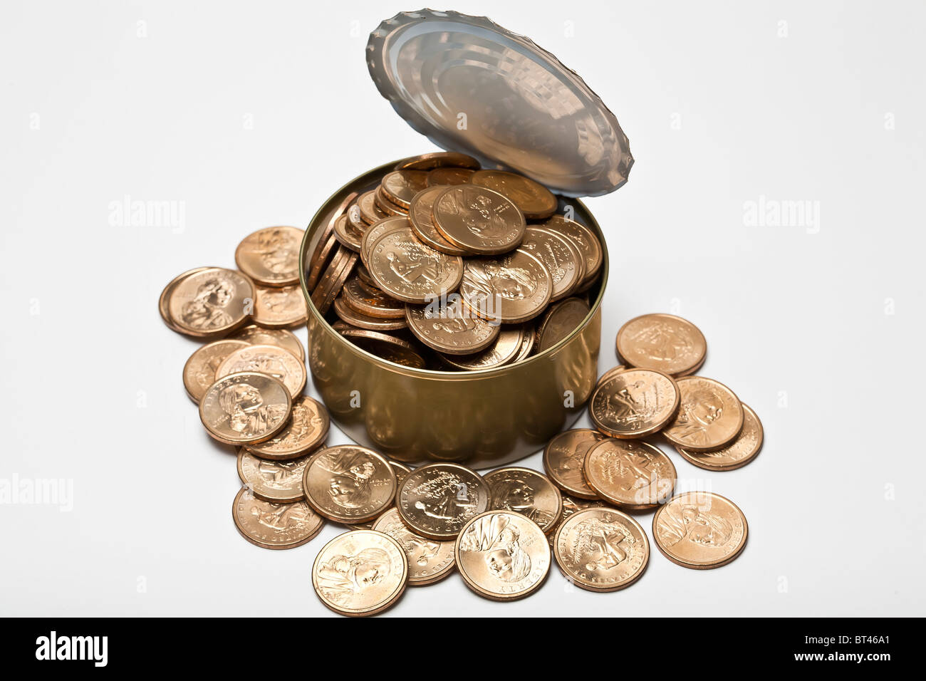 Open can of gold US dollar coins Stock Photo - Alamy