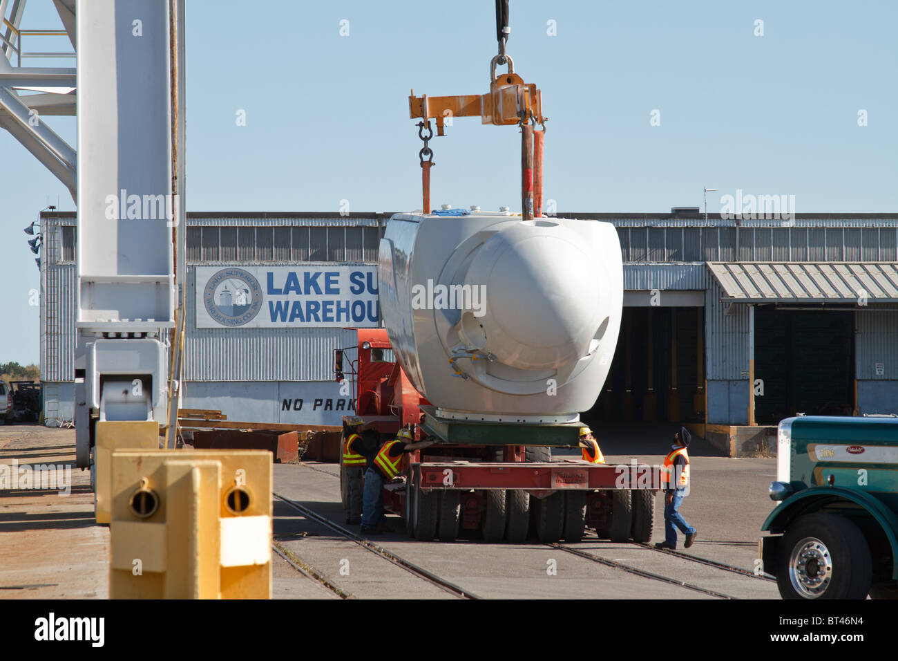A wind turbine gets loaded onto a semi at a port terminal in Duluth ...