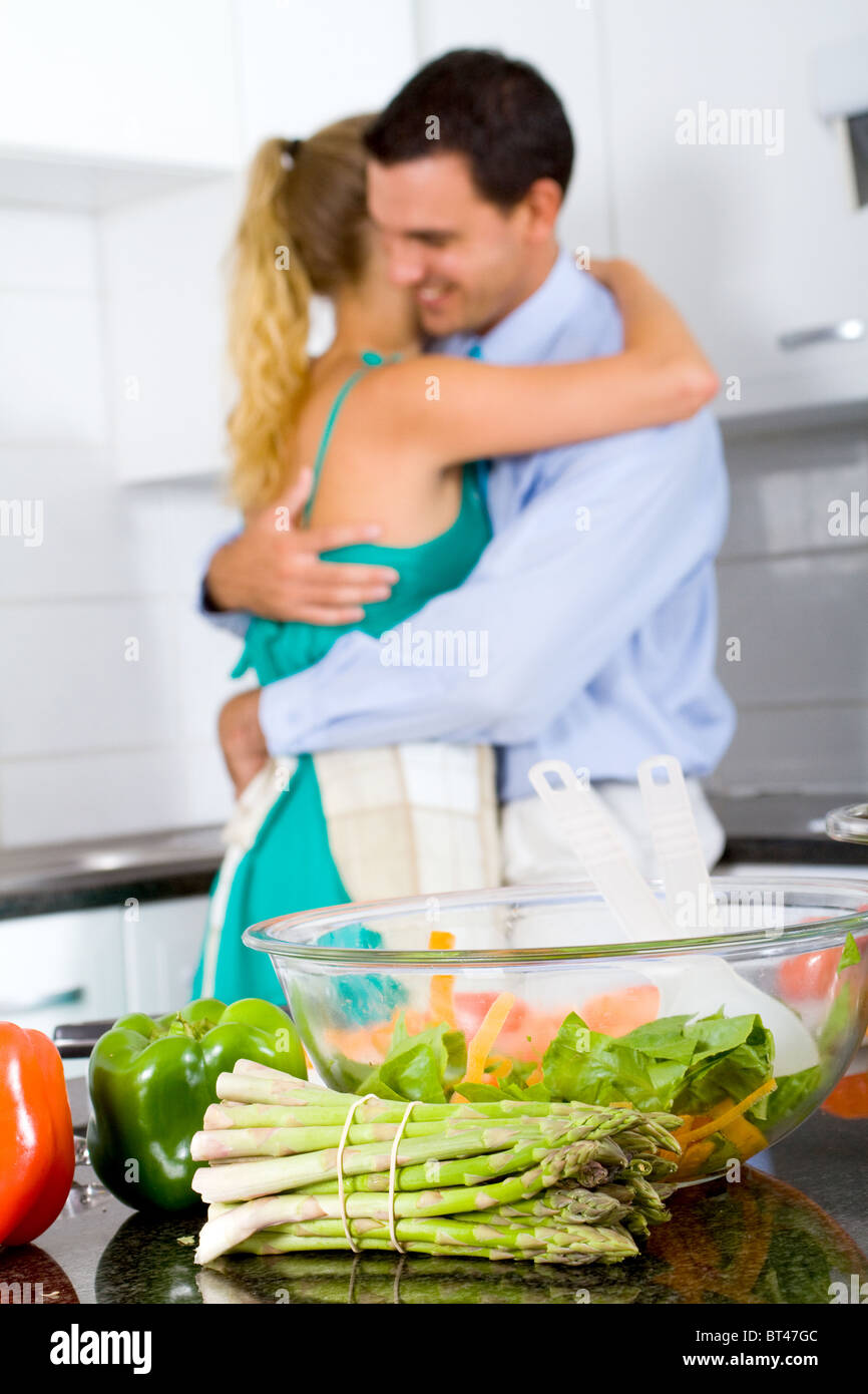 young couple hugging in kitchen Stock Photo - Alamy
