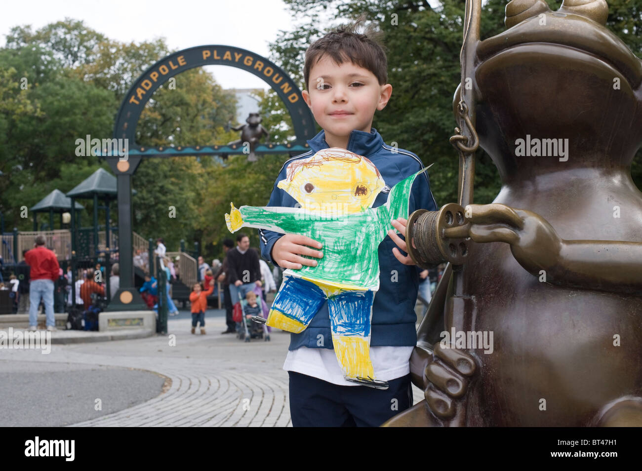 Five year old boy holds up a "Flat Stanley" drawing as part of a ...