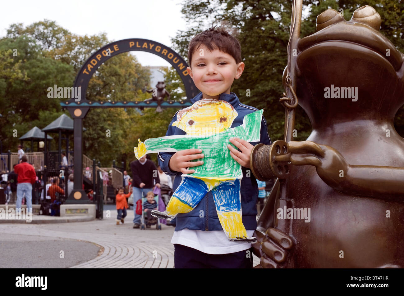 Five year old boy holds up a "Flat Stanley" drawing as part of a ...