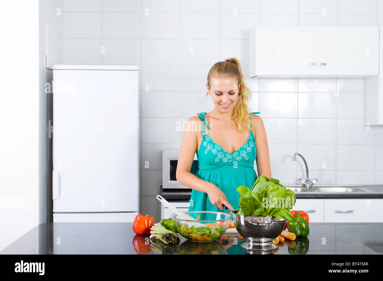 young woman preparing food in kitchen Stock Photo - Alamy
