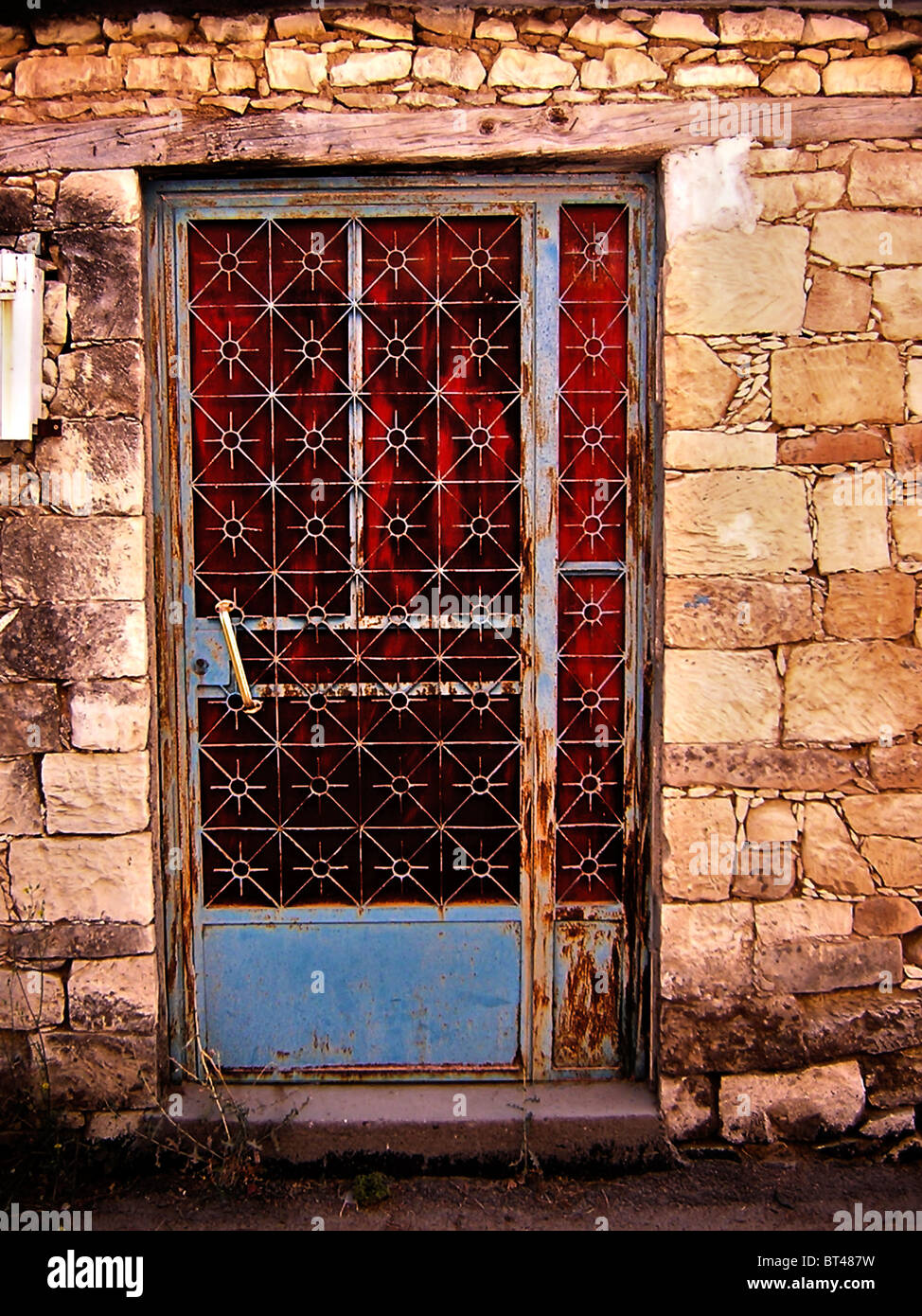 A decorative door with metal frame rusty with rough stone wall Stock ...