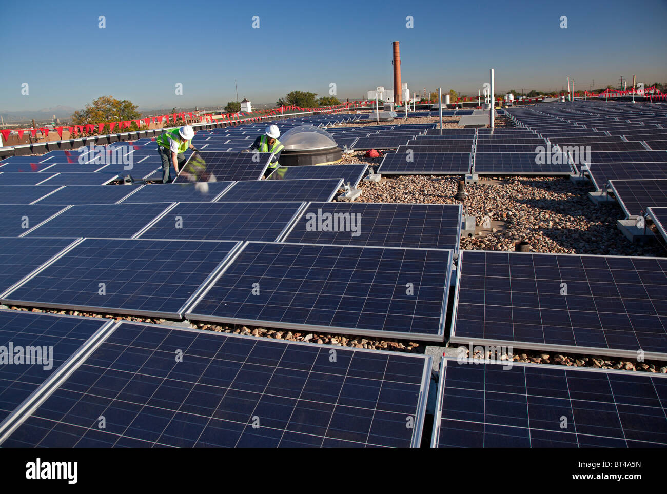 Denver, Colorado - Workers install solar photovoltaic panels on the ...