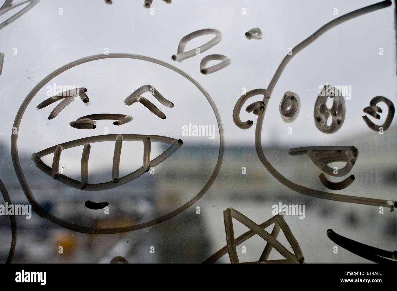 smiley cartoon character on a glass window Stock Photo - Alamy