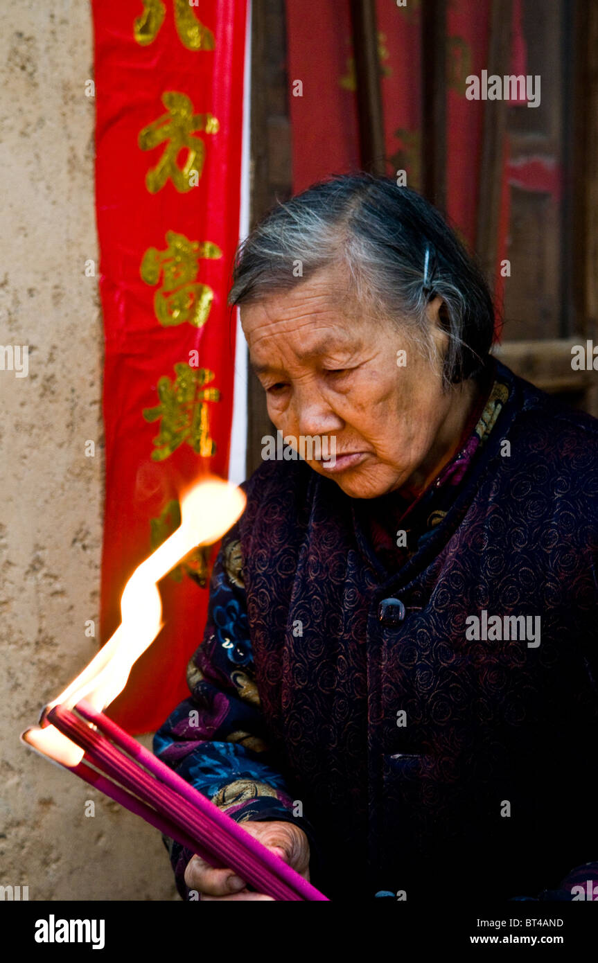 Lighting up the incense sticks in a temple in Fujian, China Stock Photo ...