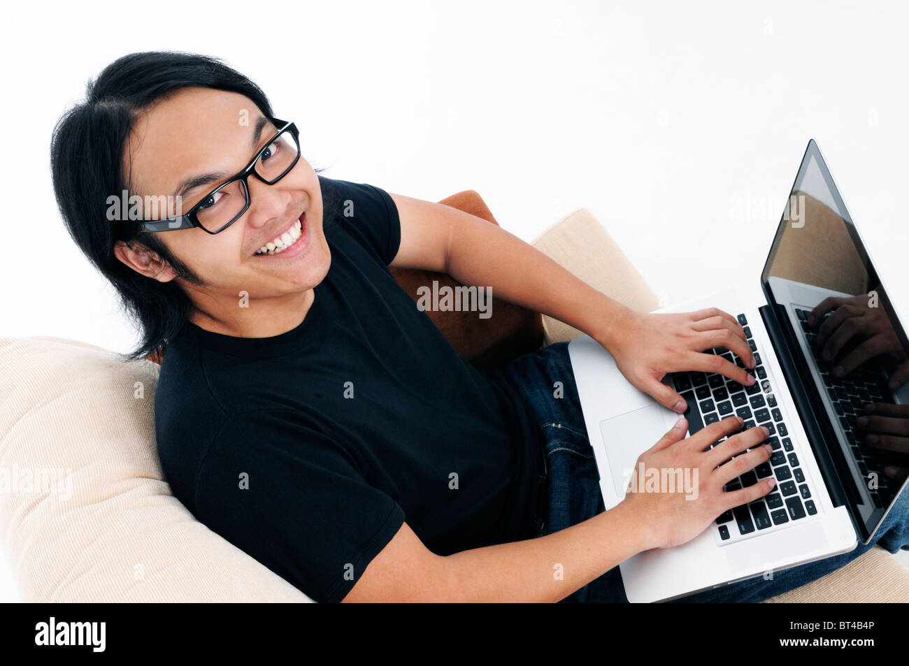 Happy young man using laptop, portrait Stock Photo - Alamy