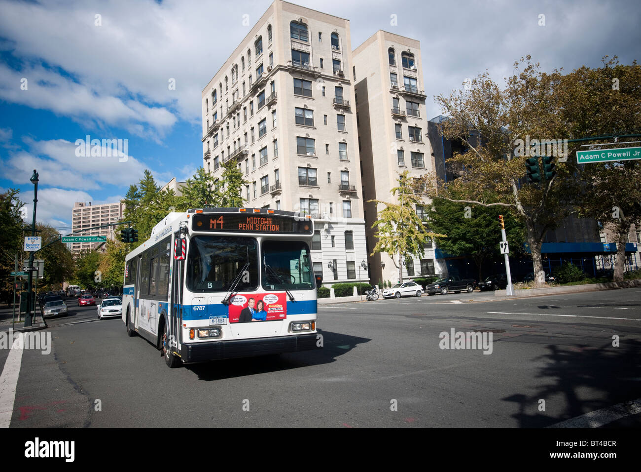 A NYC Transit bus travels through an intersection on Central Park North ...
