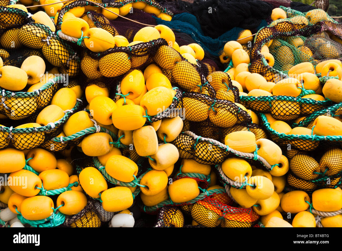 Closeup on fishing net with yellow floaters stored on fisher boat ...